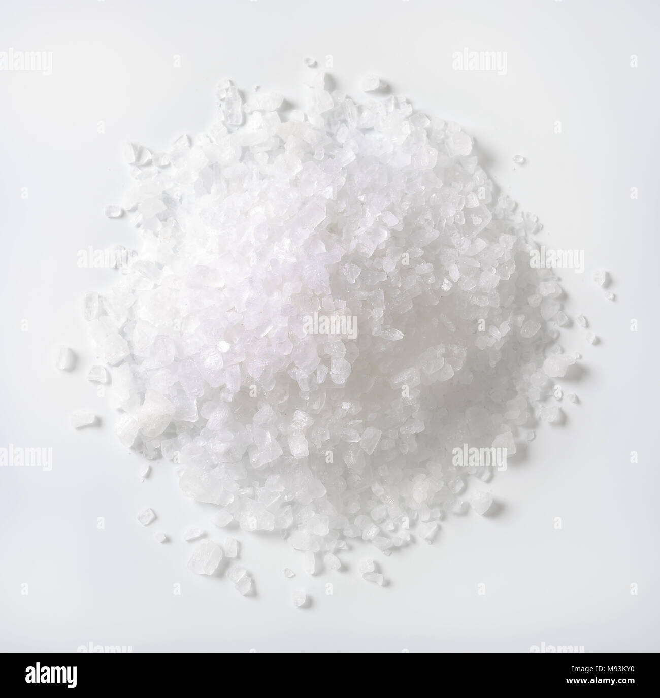 pile of coarse grained sea salt on white background Stock Photo - Alamy