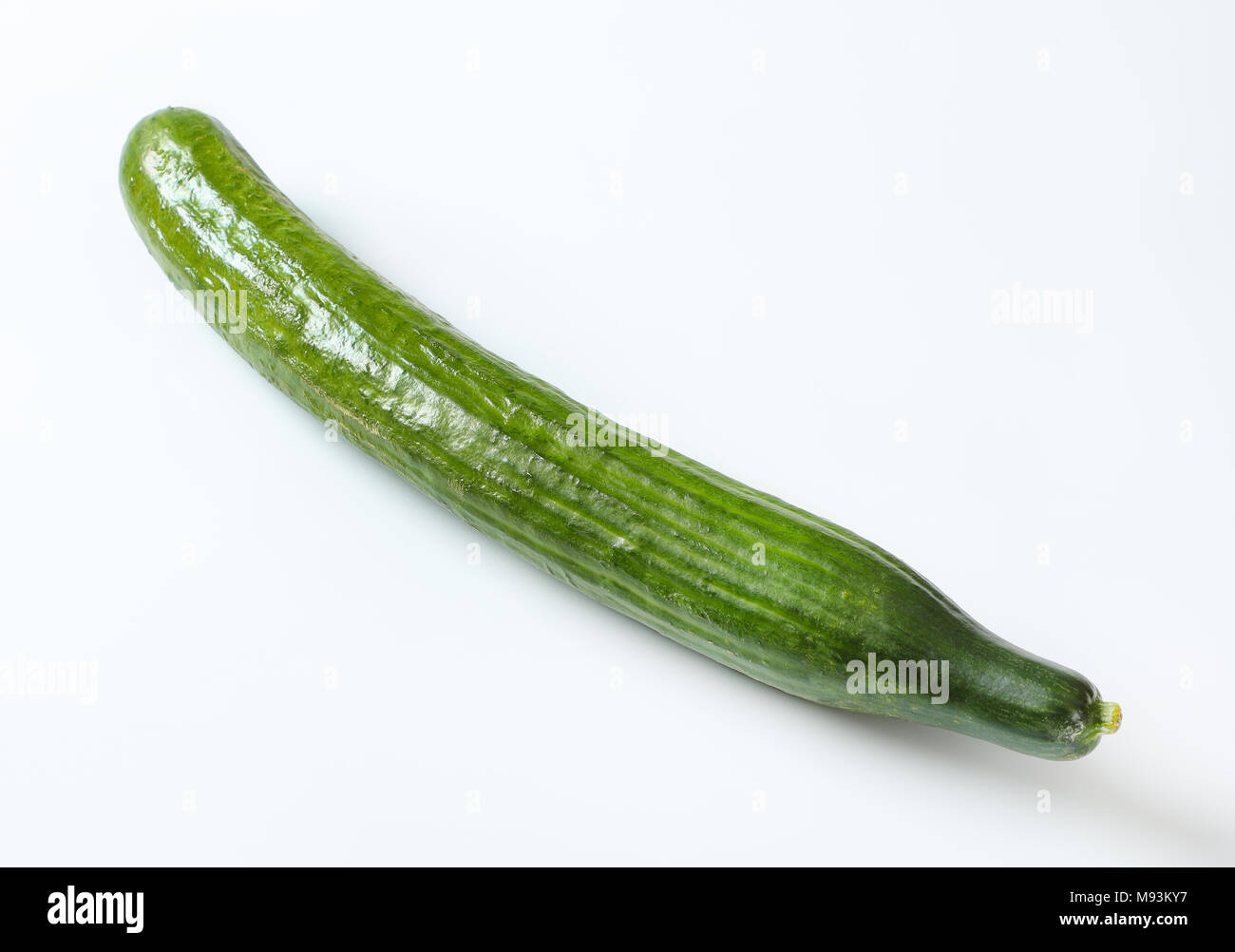 single long cucumber on white background Stock Photo - Alamy