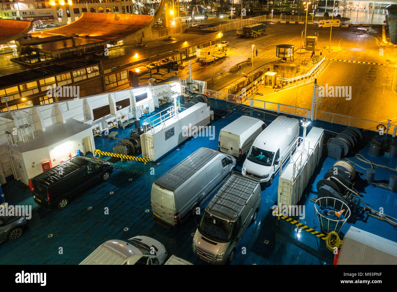 Loading vehicles onto a roll on roll off ferry at night in Santander ...