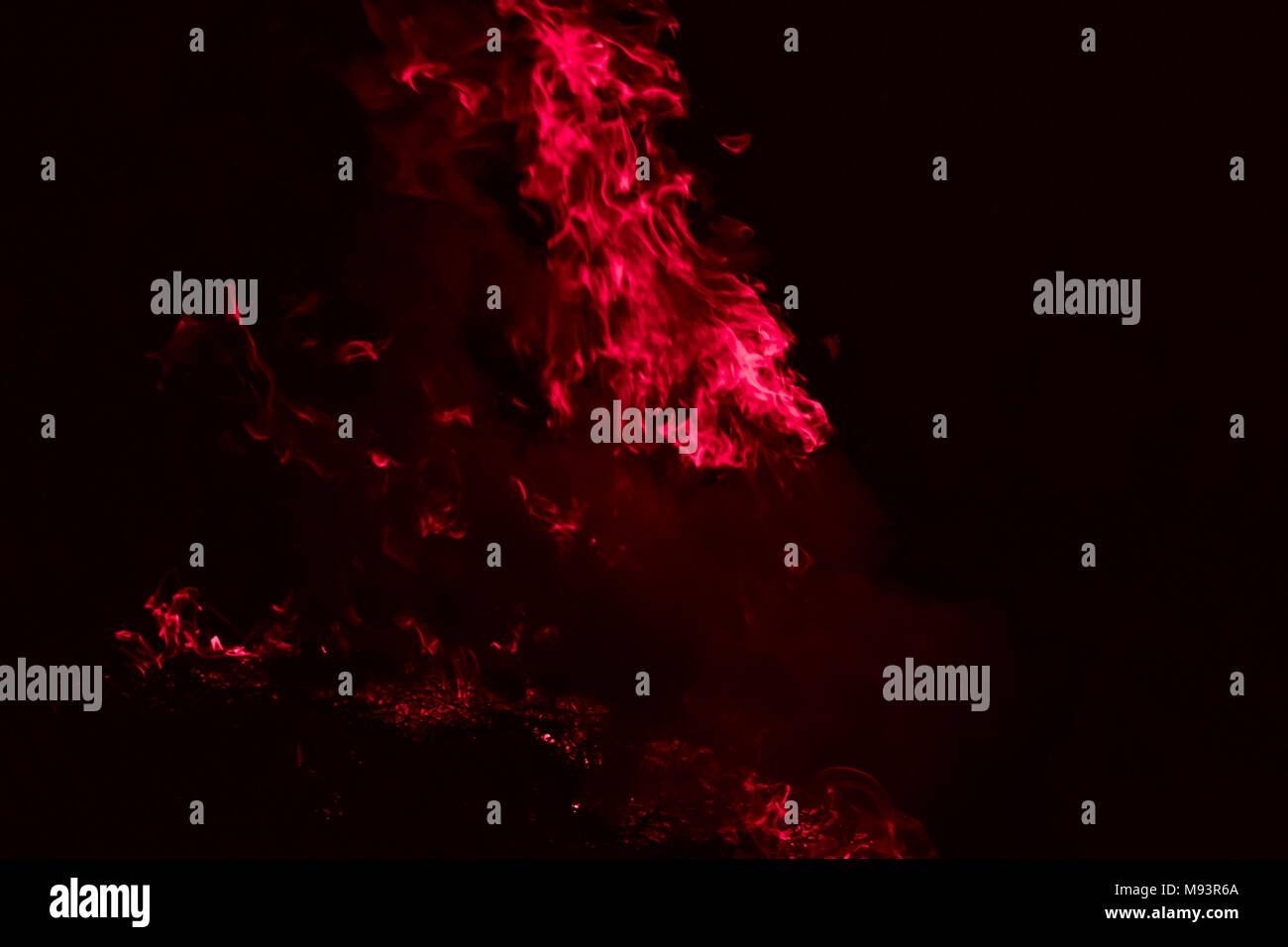 A dark red flame. Burning of rice straw at night Stock Photo - Alamy