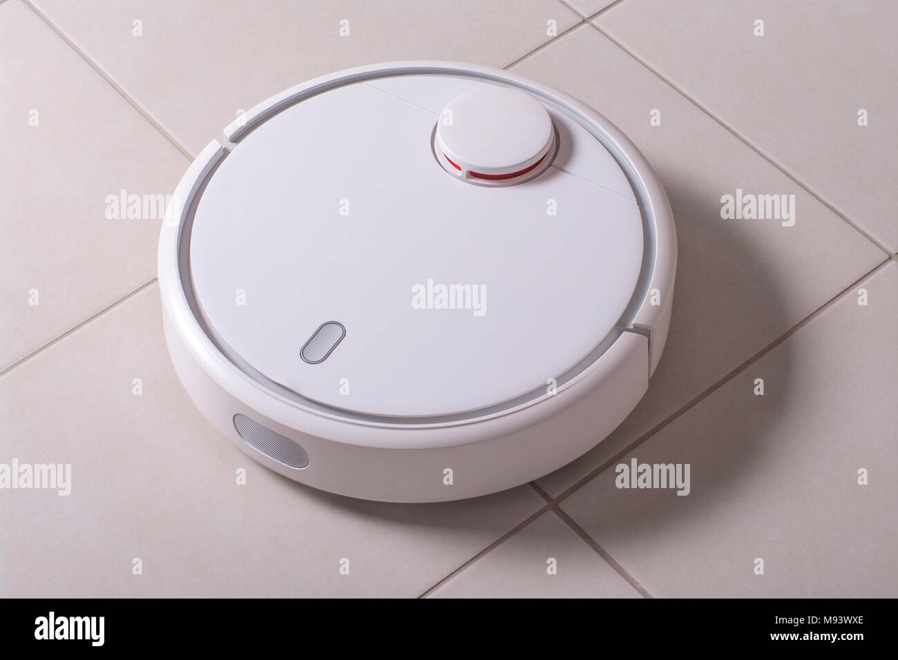Robot vacuum cleaner cleaning dust on tile floors. Modern smart ...
