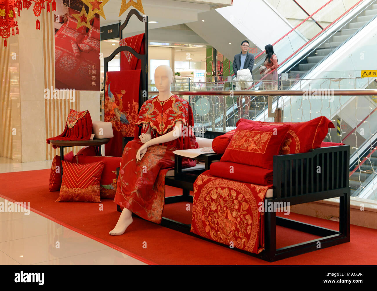 Traditionally patterned linen and clothing on display in a shopping ...
