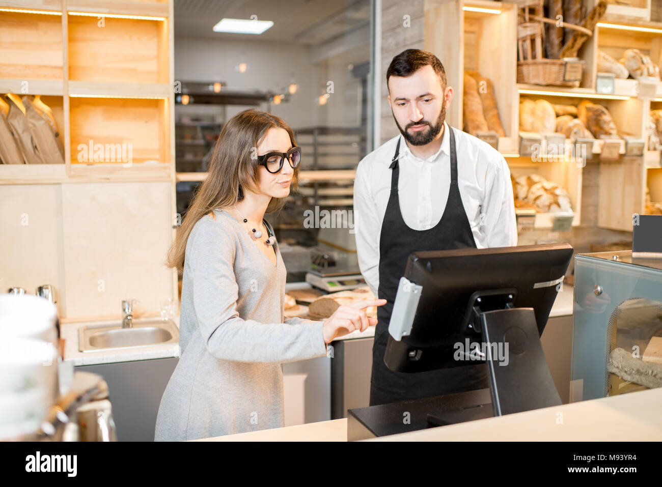 Owner of the bakery store with bread seller Stock Photo - Alamy