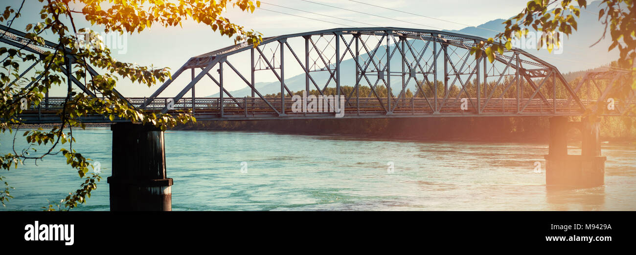 Metal bridge over the river Stock Photo - Alamy