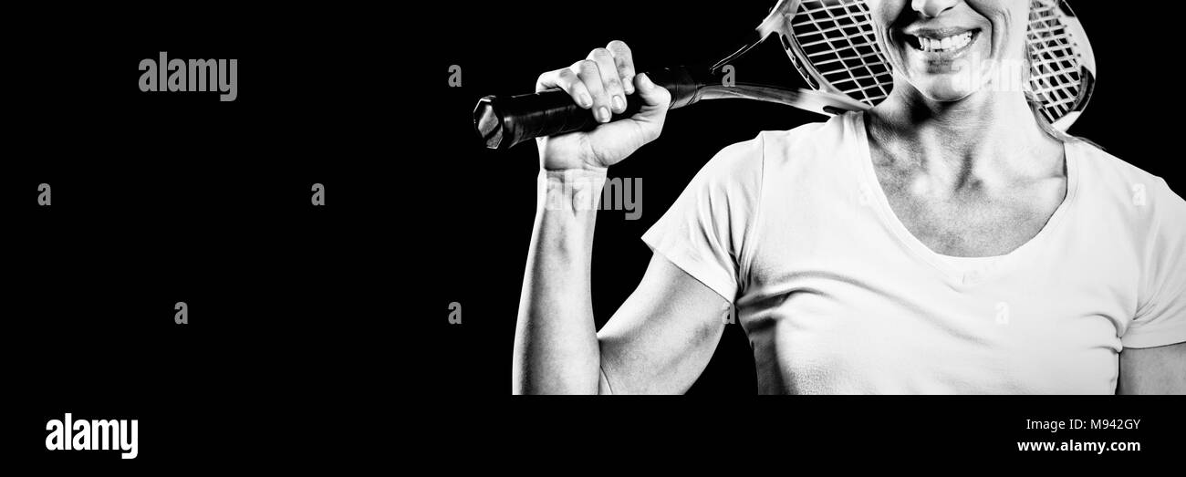 Portrait of female tennis player posing with racket Stock Photo - Alamy