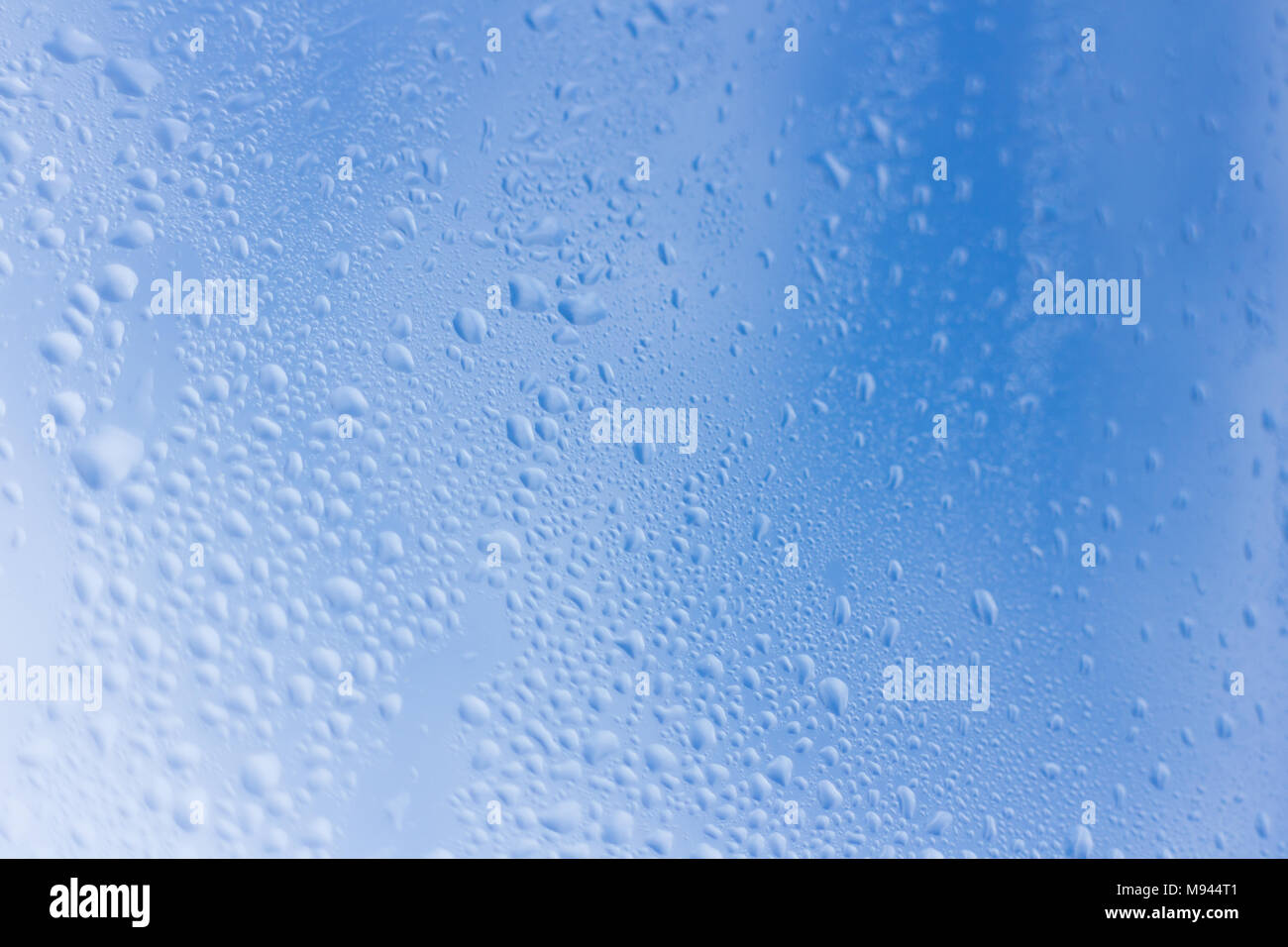 Wet blue glass with rain drops on surface Stock Photo - Alamy