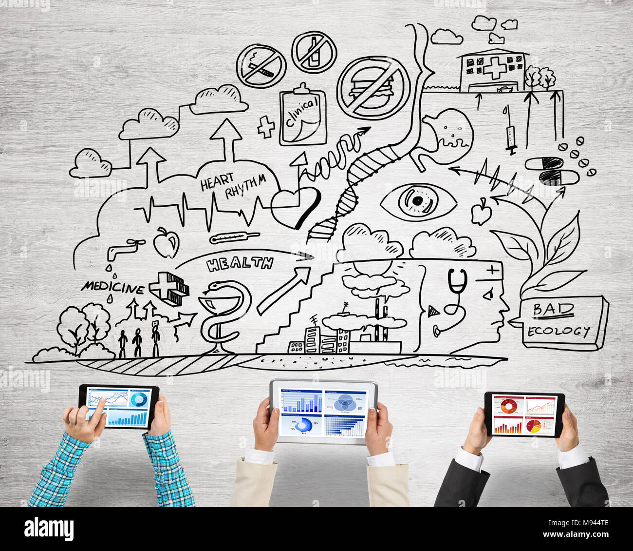 Group of three people with devices in hands working together as symbol ...