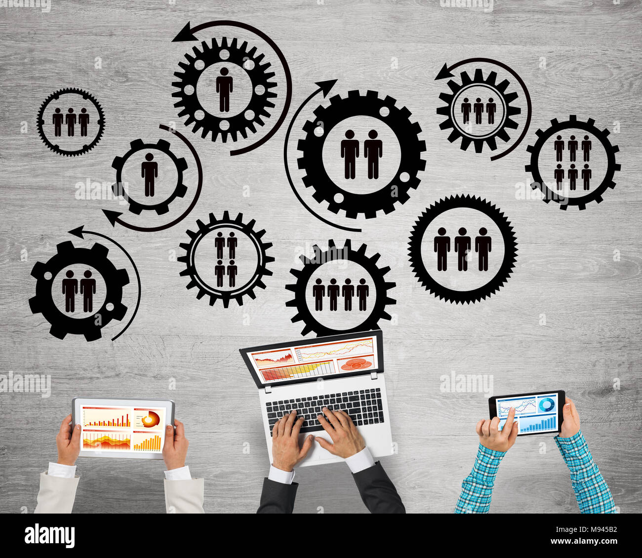 Group of three people with devices in hands working together as symbol ...