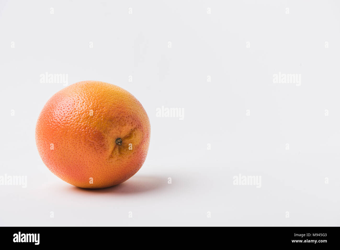 raw unpeeled orange laying on white background Stock Photo - Alamy