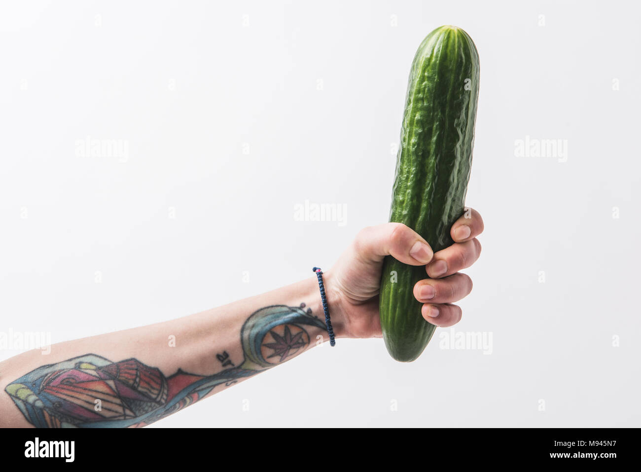 Hand holding green cucumber isolated on white background Stock Photo ...