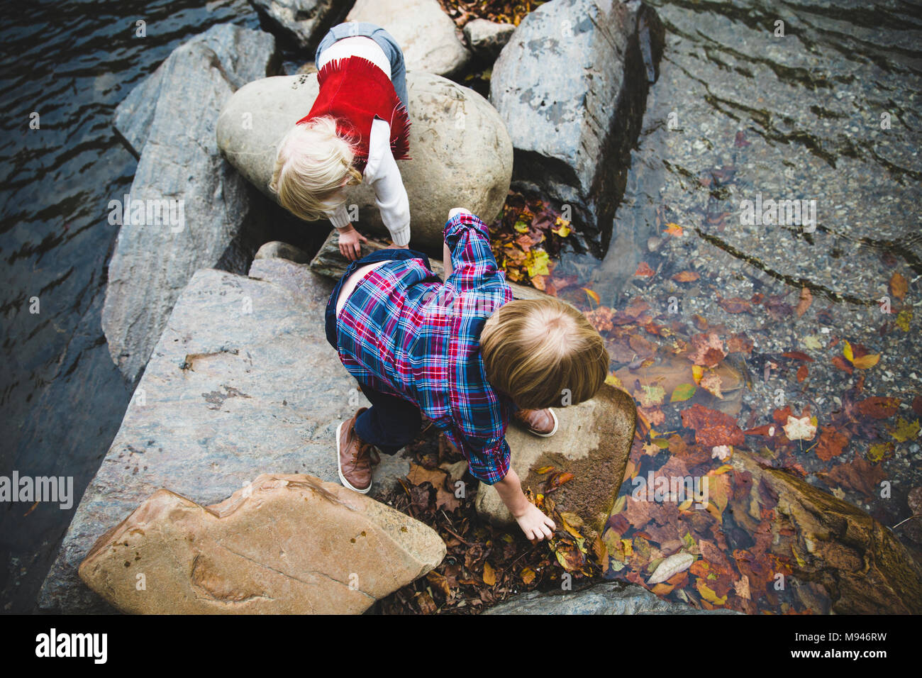 Two children playing on rocks hi-res stock photography and images - Alamy