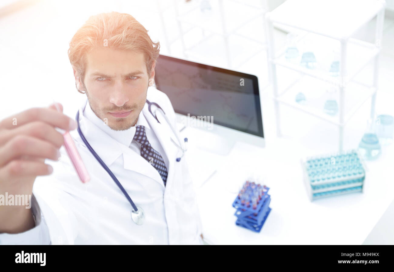 Man in laboratory checking test tubes Stock Photo - Alamy