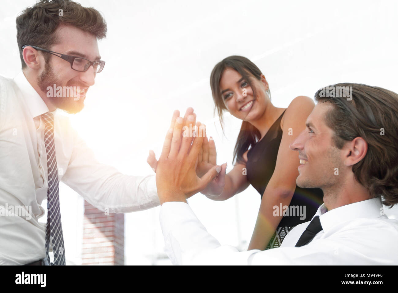 members of the business team give each other high five Stock Photo - Alamy