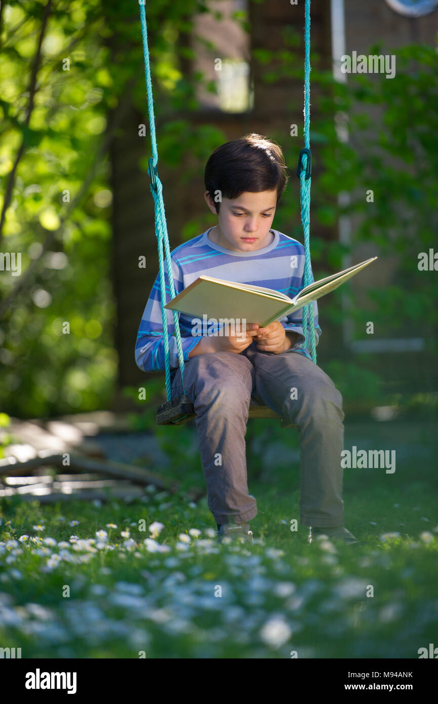 Reading on a swing hi-res stock photography and images - Alamy