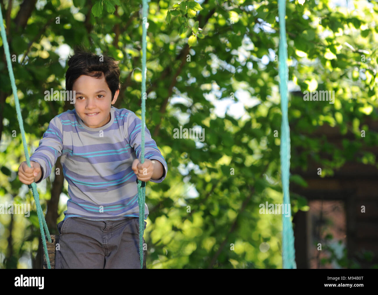 Child playing with a swing in a park Stock Photo - Alamy