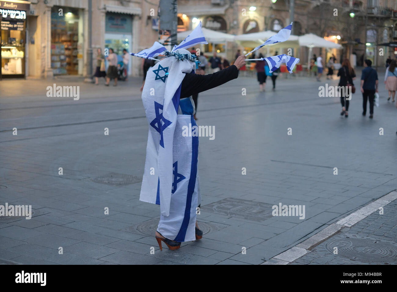 A Jewish woman wrapped with the Israeli flag dancing and singing ...