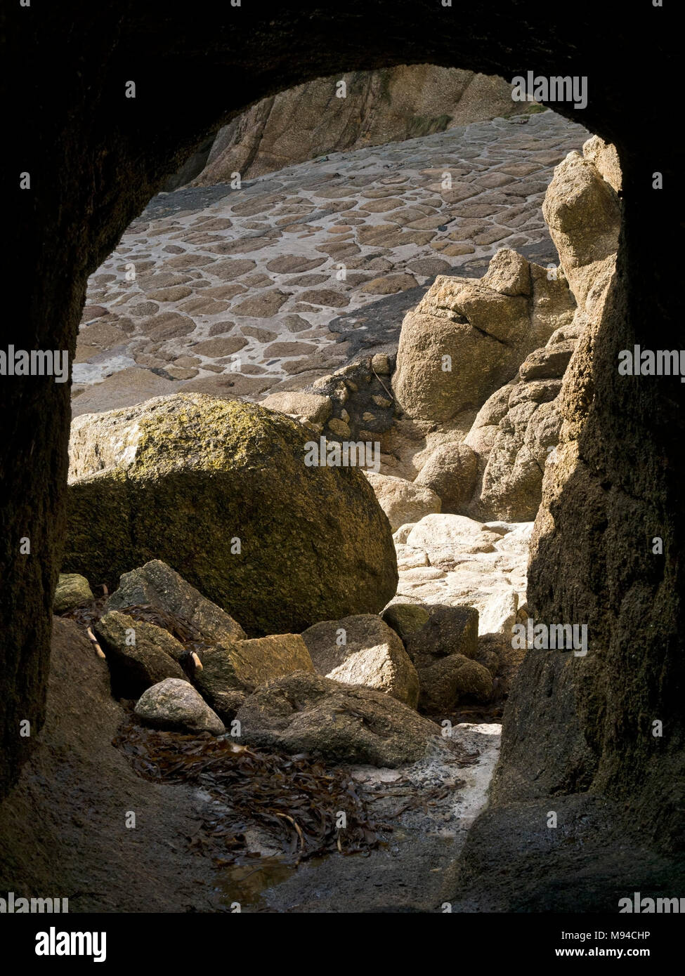 Cave tunnel in cliffs at Porthgwarra Cove used during filming of BBC TV ...