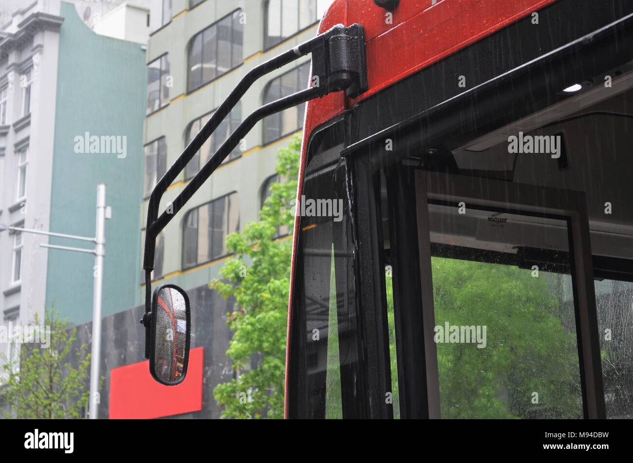 front of red bus in sideview while raining in Auckland city Stock Photo ...