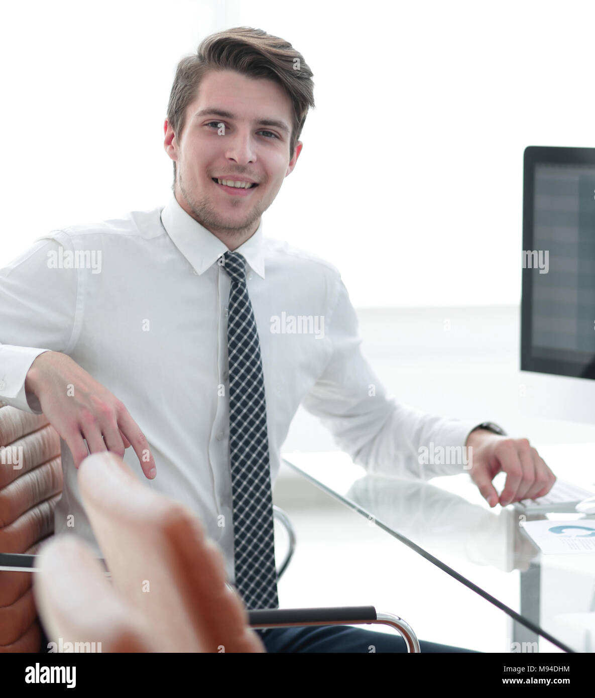 employee sitting in front of a computer screen Stock Photo - Alamy