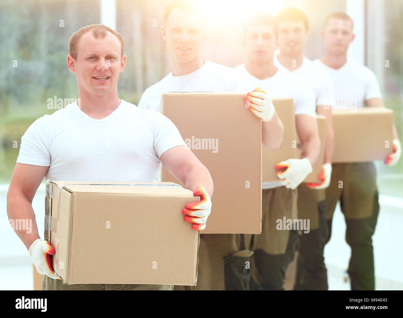 team of builders with boxes of building materials Stock Photo - Alamy