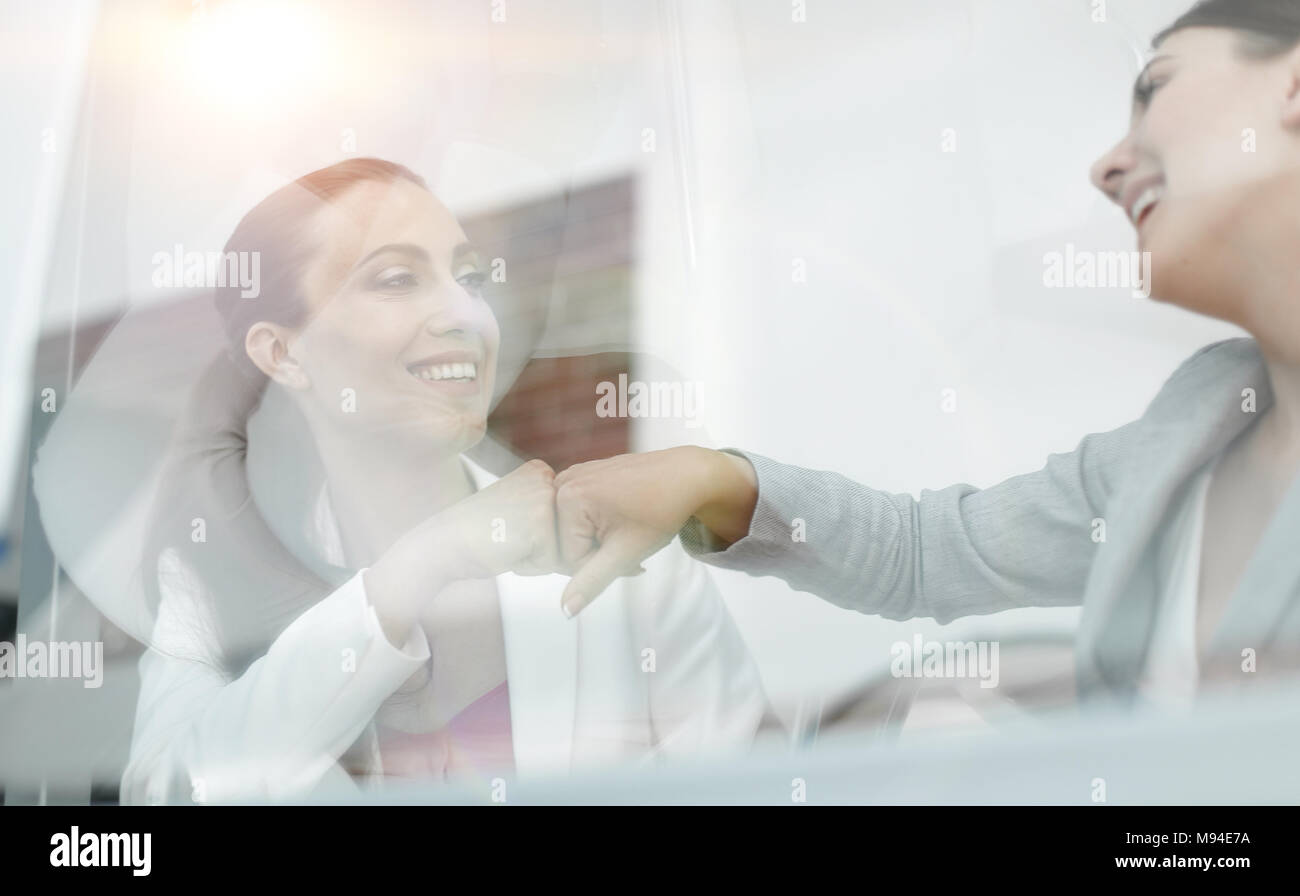 behind the glass.colleagues celebrate their success Stock Photo - Alamy
