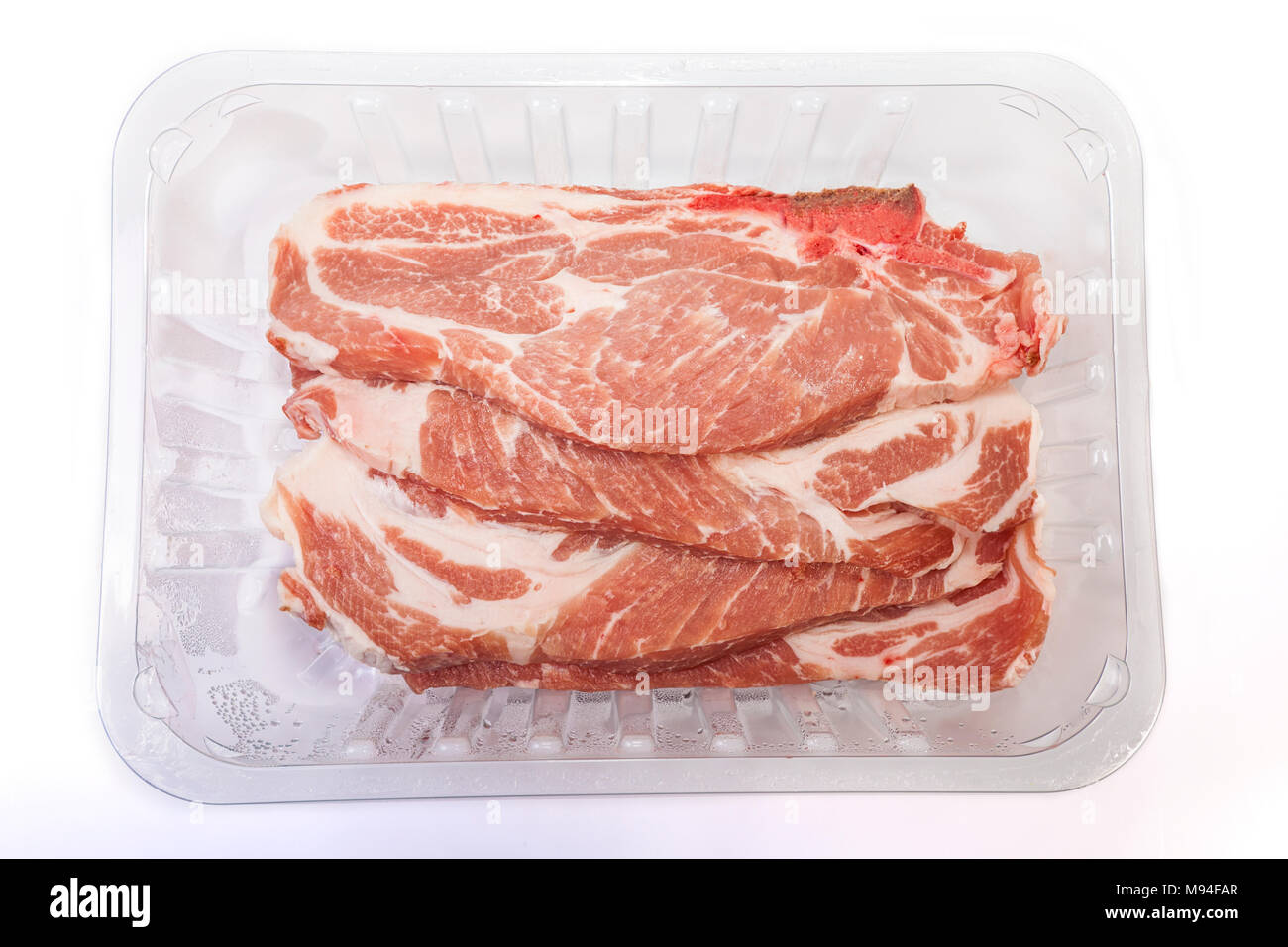 Middle rib chops of pork on the package. Isolated on white Stock Photo ...
