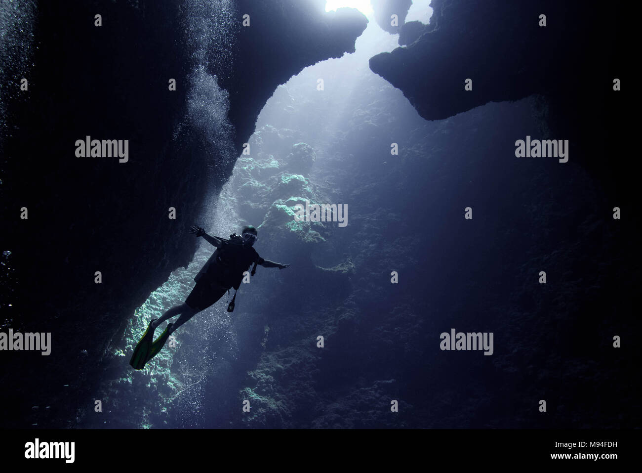 Diver coming up the Blue Hole dive site in Pacific, off Palau Stock ...