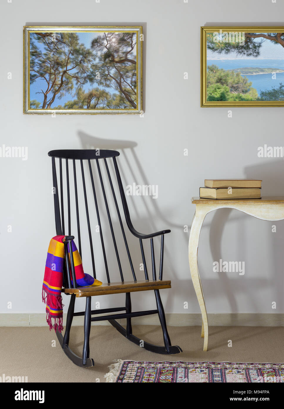 Interior shot of classic rocking chair and two old books on old style ...