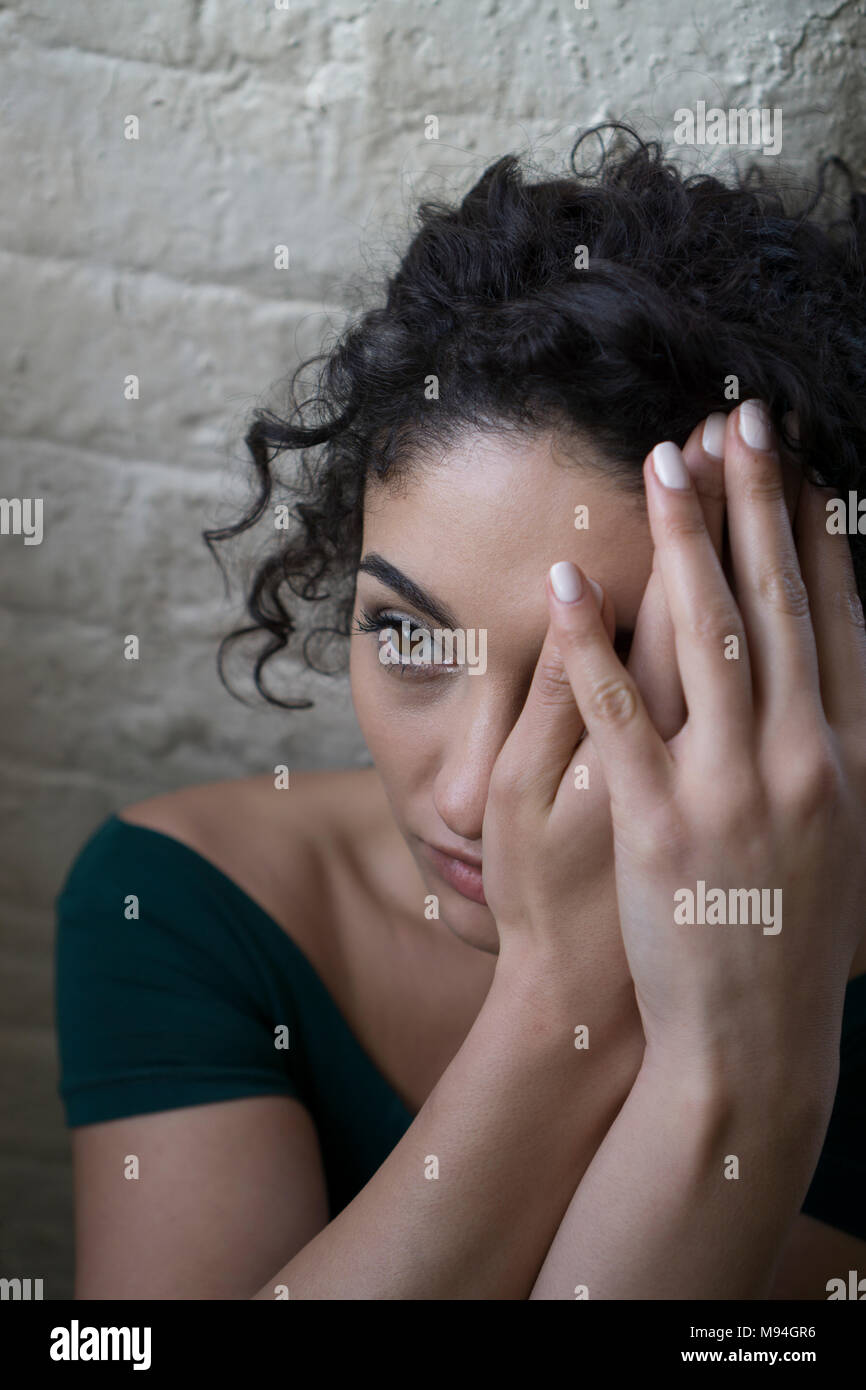 Portrait of a young woman hiding face with hands Stock Photo - Alamy