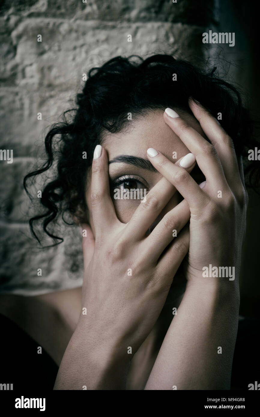 Portrait of a young woman hiding face with hands Stock Photo - Alamy