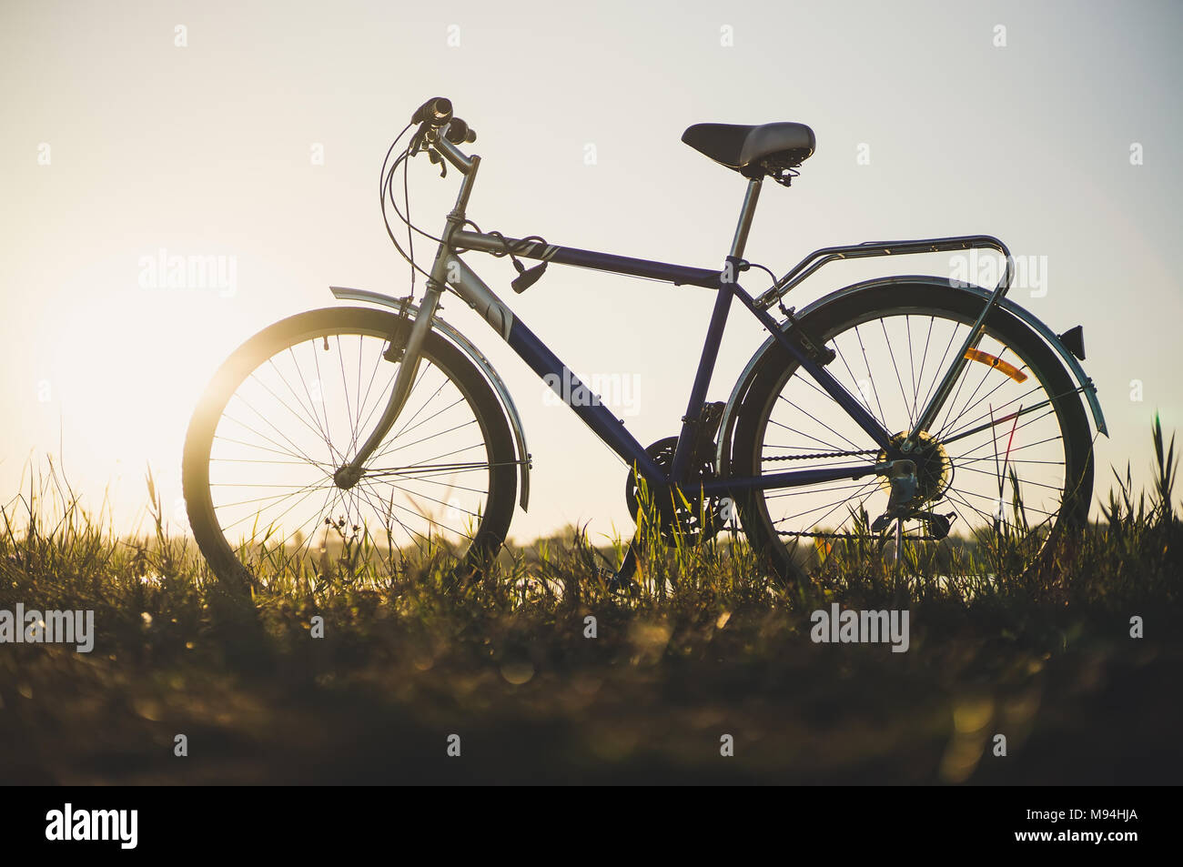 Traveling by bicycle. Beautiful scenery with a bicycle. Sunset on the ...