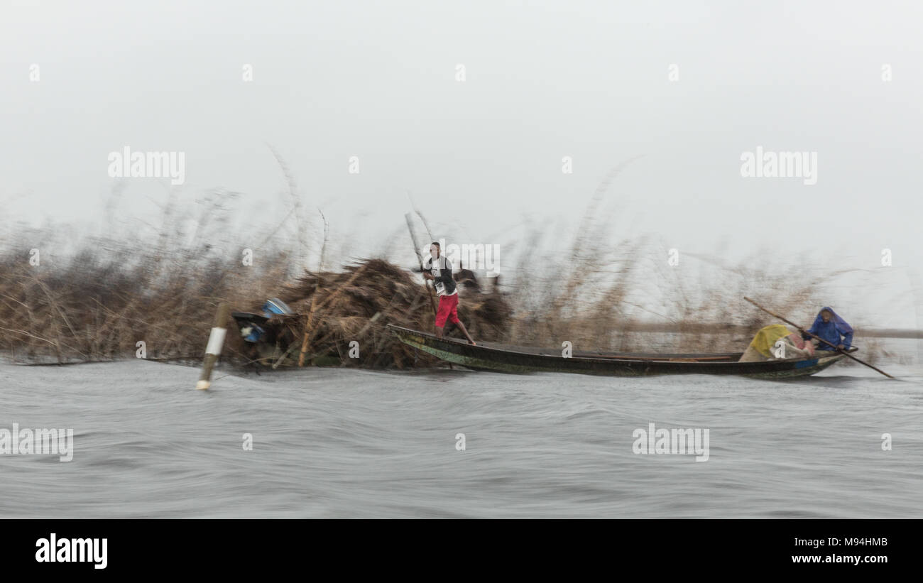 Fisherman struggle in heavy rain and howling winds on Lake Nokoué ...
