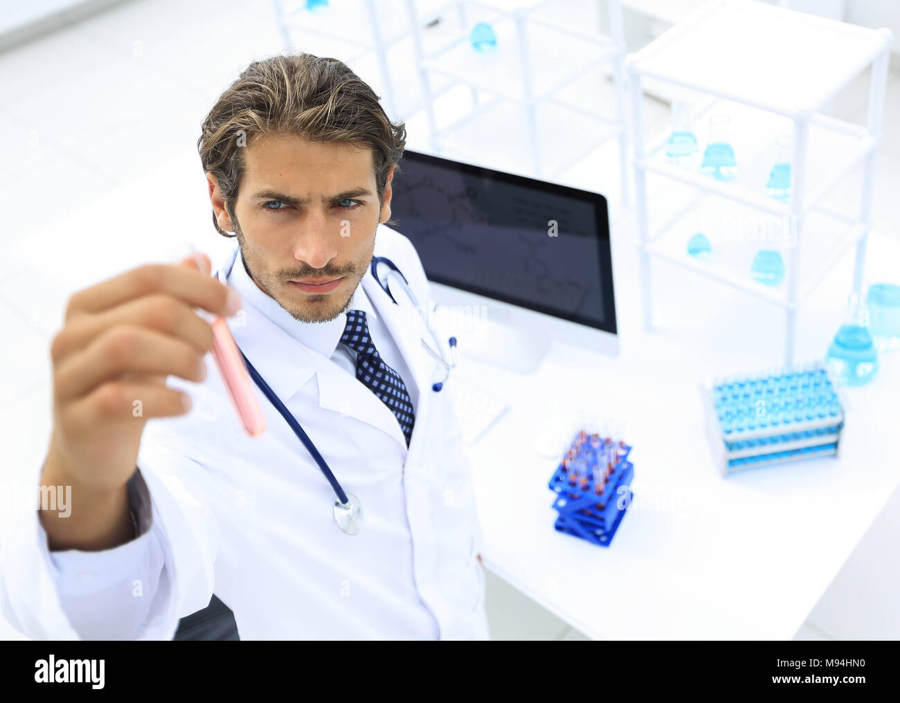 Man in laboratory checking test tubes Stock Photo - Alamy