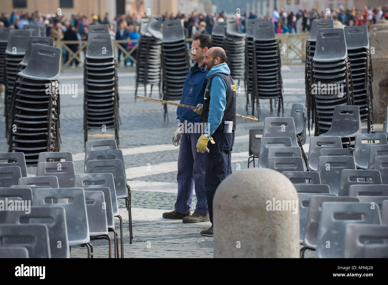 Vatican City. Workers arrange the chairs in the areas intended for ...