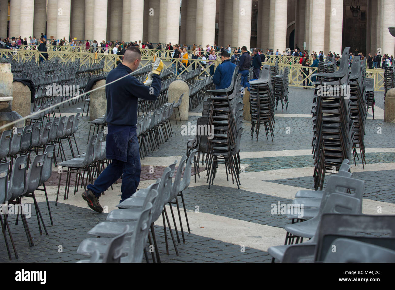 Vatican City. Workers arrange the chairs in the areas intended for ...
