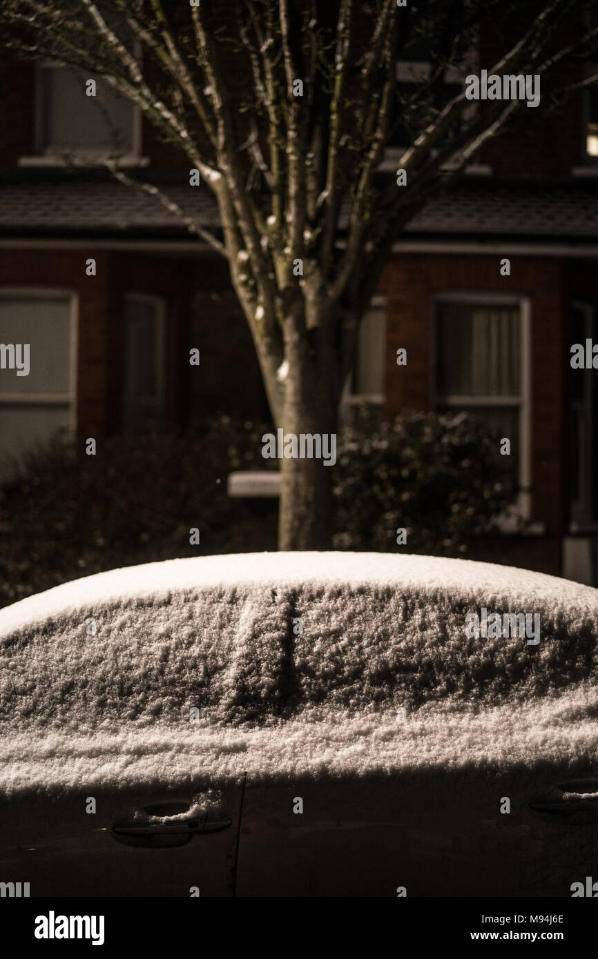 Cars on a suburban street in London after a light downfall of snow ...