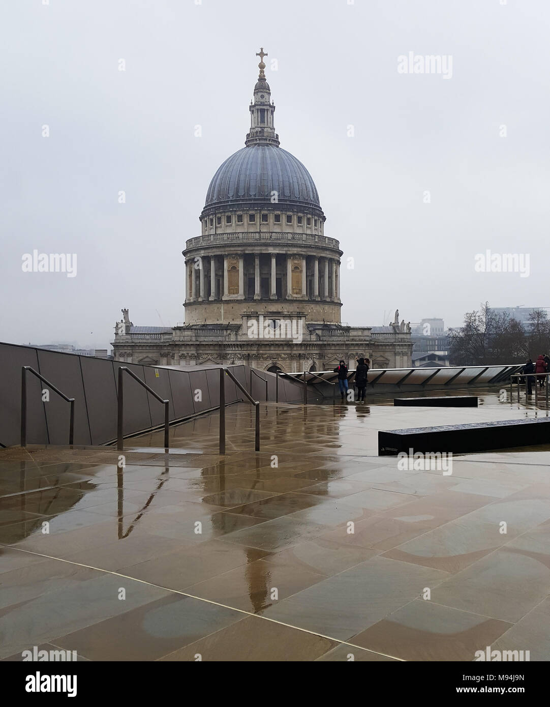 Cloudy with patchy rain and drizzle in London. Featuring: A reflection ...