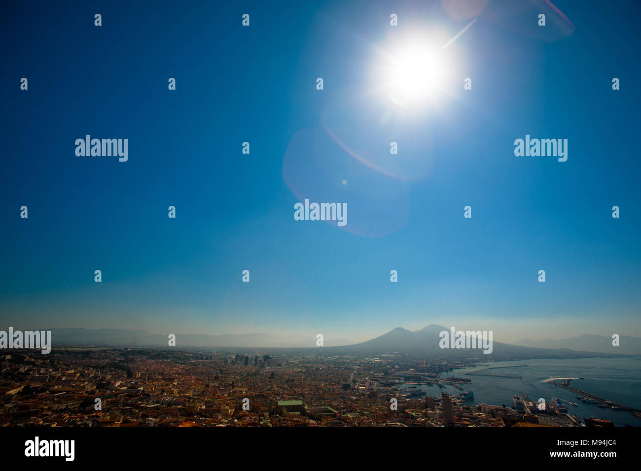 The sun sits high on summers day overlooking Mount Vesuvius, Naples ...