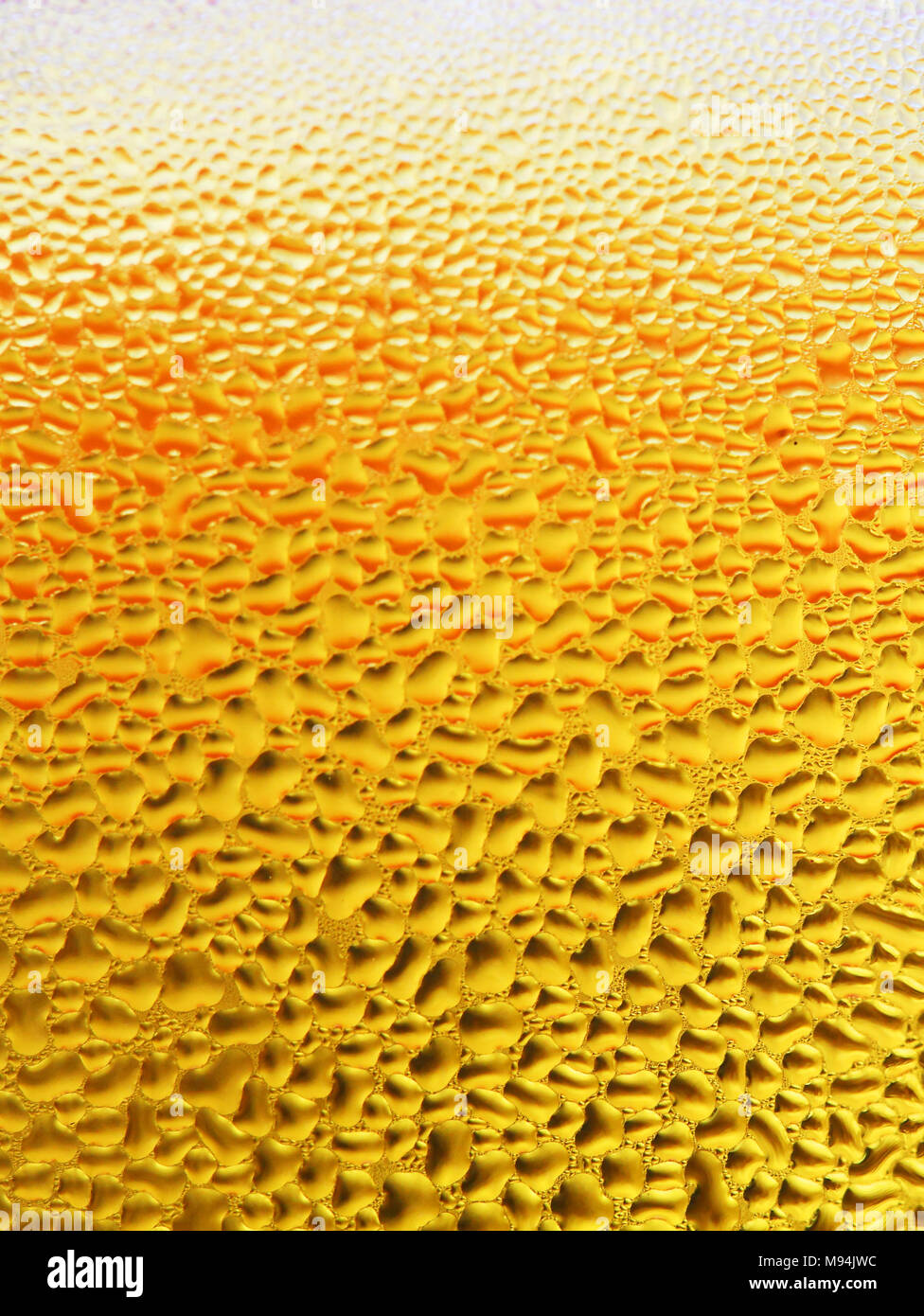 Beer bubbles macro yellow background Stock Photo - Alamy