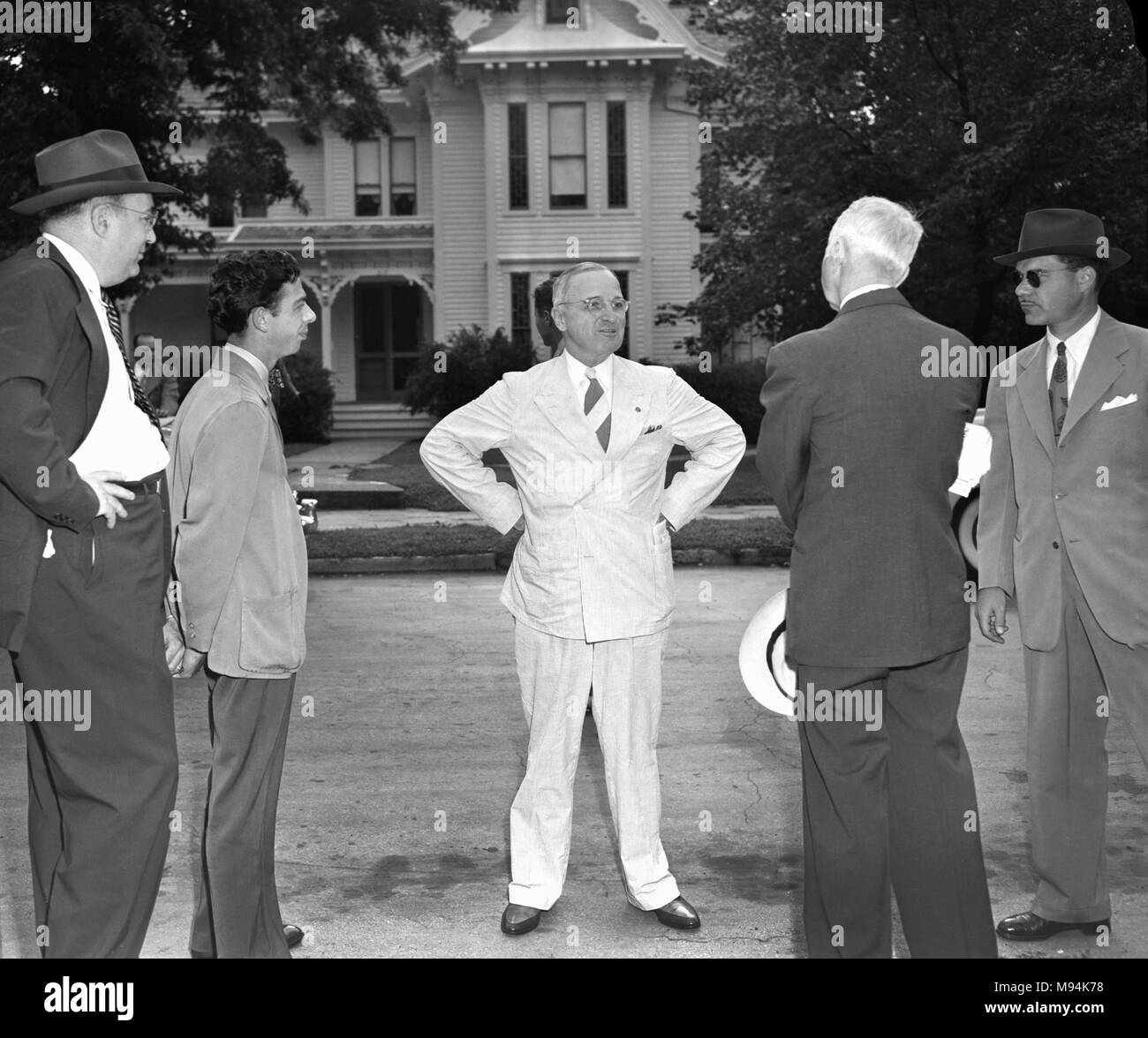 President Harry S. Truman stands and talks in front of his home in ...