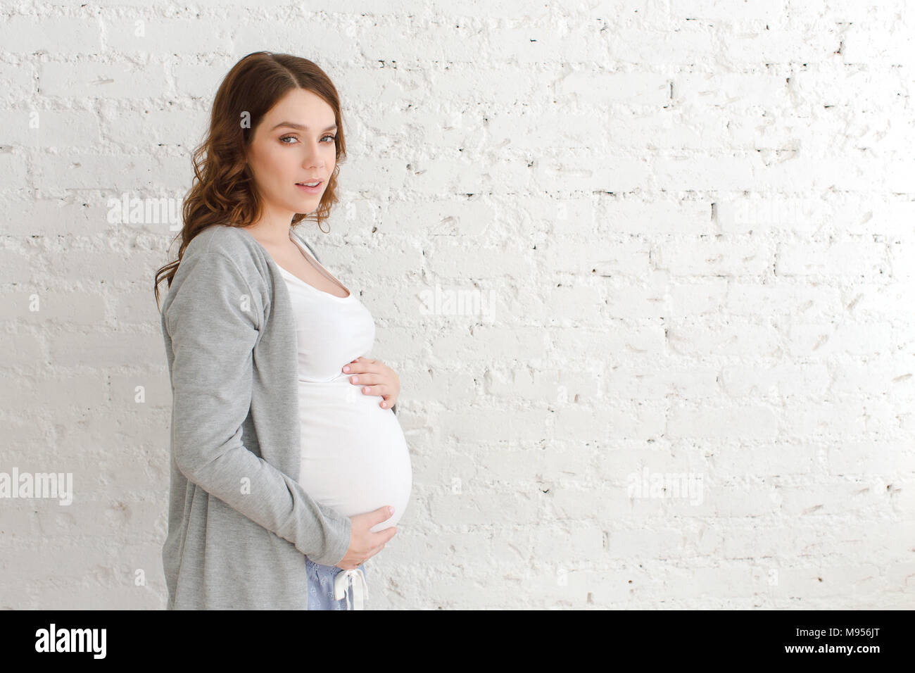 Pregnant female posing looking at camera Stock Photo - Alamy