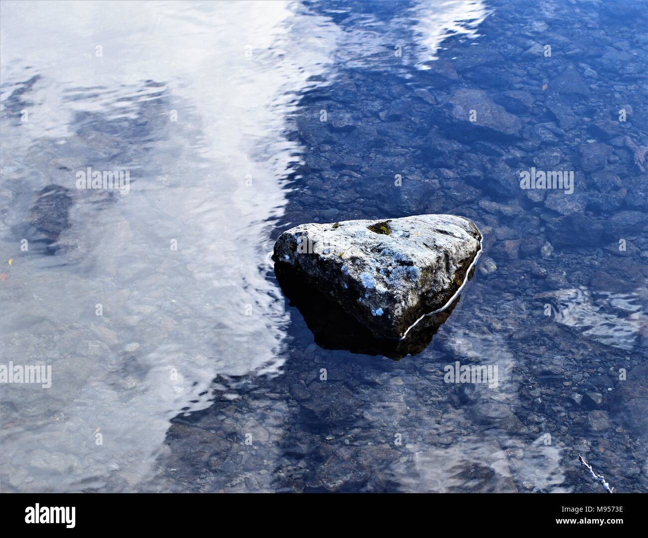 Rock in Water Stock Photo - Alamy