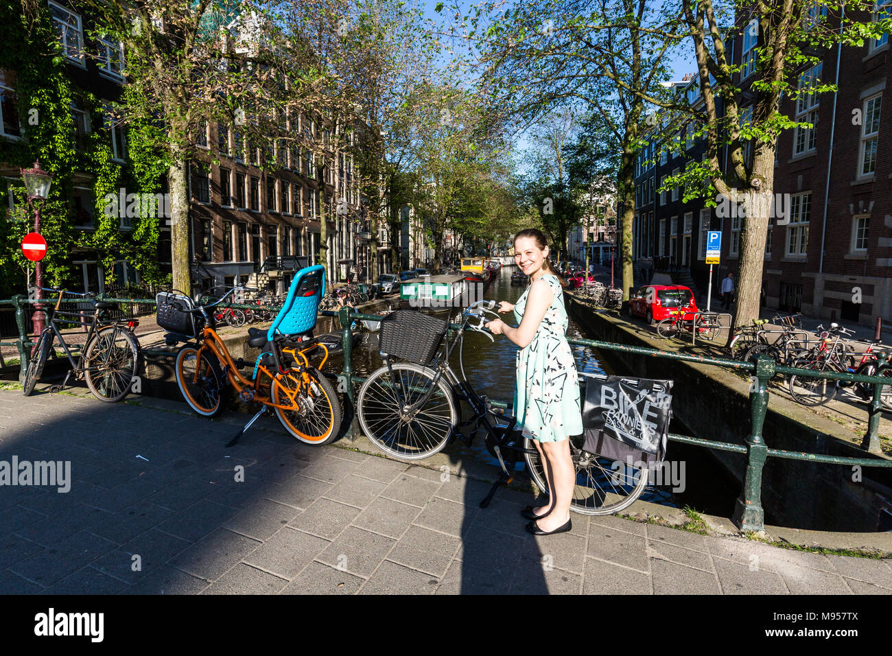 AMSTERDAM, NETHERLANDS - MAY 26, 2017: Girl at the Raamgracht street in ...