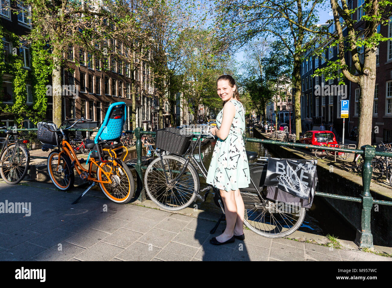 AMSTERDAM, NETHERLANDS - MAY 26, 2017: Girl at the Raamgracht street in ...