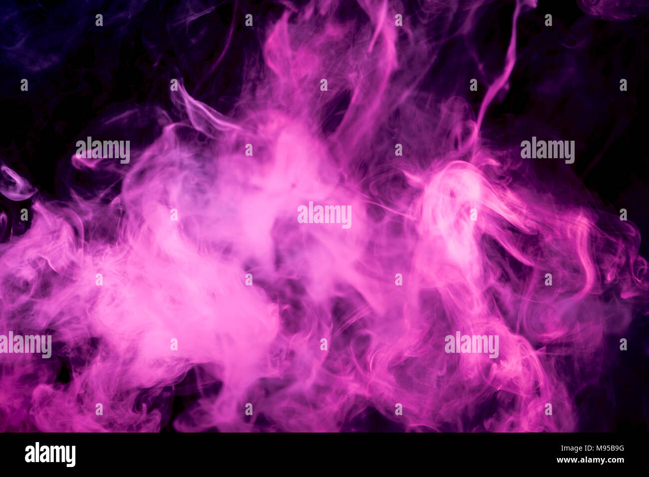 Thick pink colorful smoke on a black isolated background. Background ...