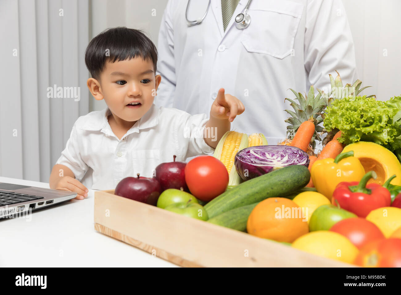 Healthy and nutrition concept. Kid learning about nutrition with doctor ...