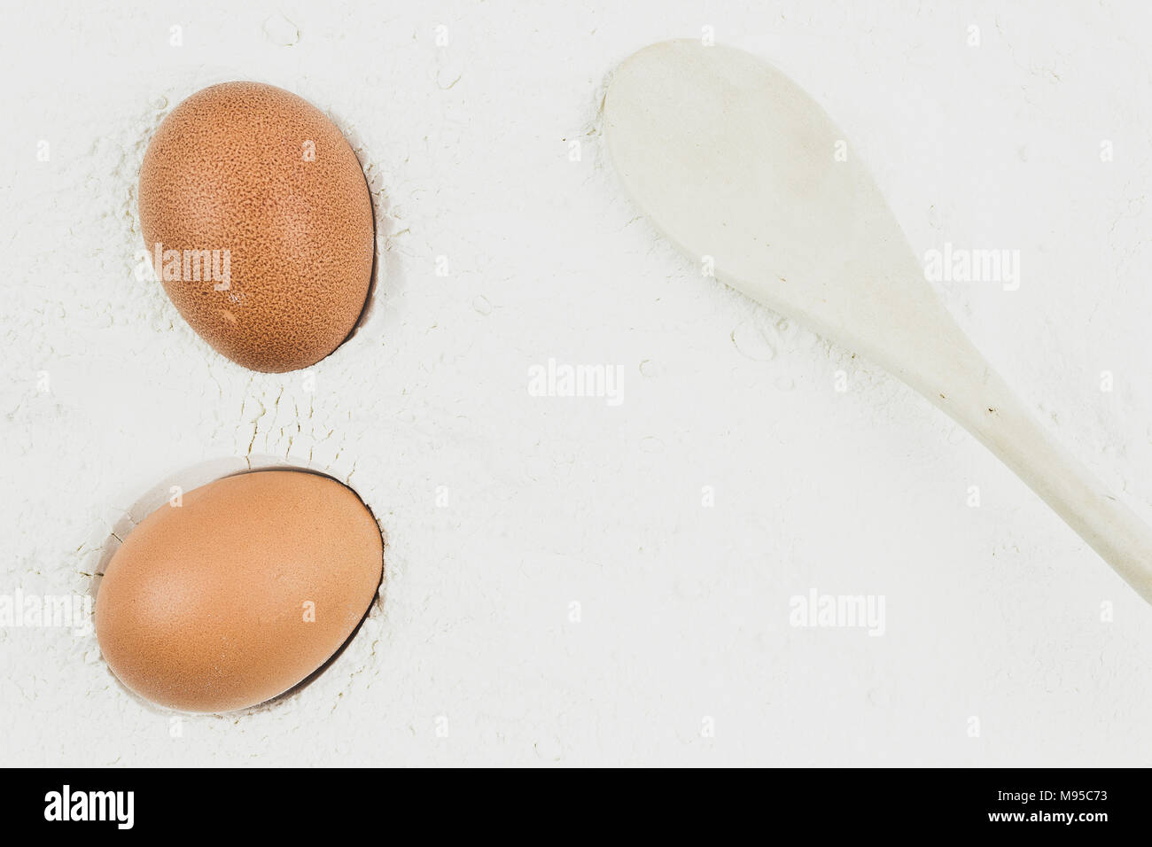Whole egg and wooden spoon on flour background. Preparation of baking ...