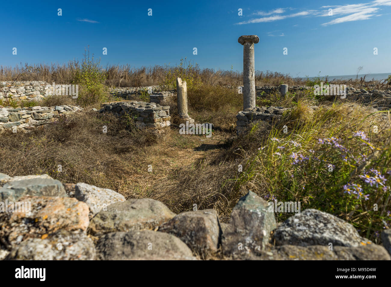 ruins of stone walls and columns of ancient castle Histria, Romania ...