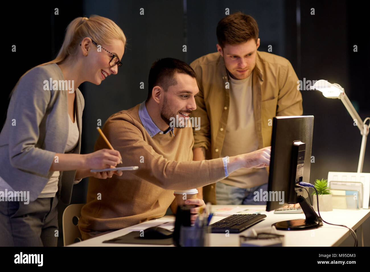 business team with computer working late at office Stock Photo - Alamy