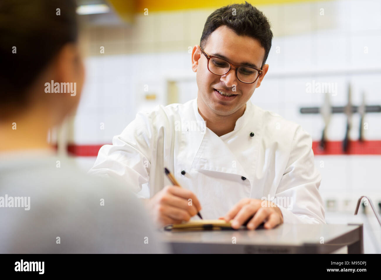 chef at fast food restaurant writing order Stock Photo - Alamy